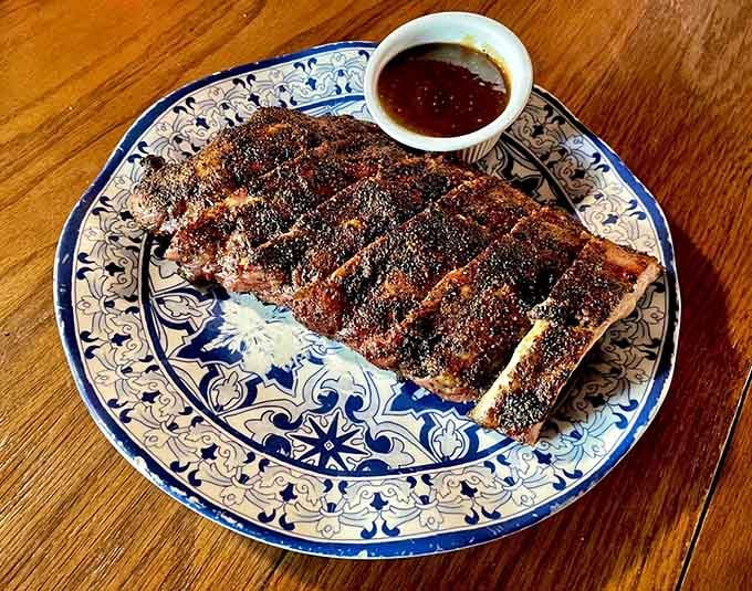 These mesquite-grilled ribs have the kind of char marks that make vegetarians question their life choices momentarily.