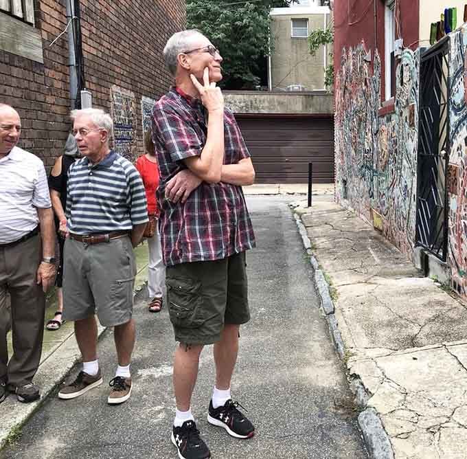 Three generations contemplating art in an alley, because great creativity makes philosophers of us all, regardless of age.