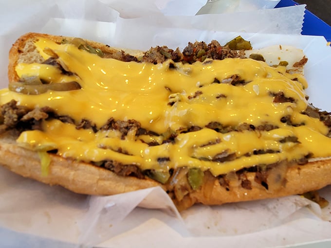 Behold the cheesesteak in its purest form—thinly sliced meat, melted cheese, and peppers creating simple perfection on a roll.