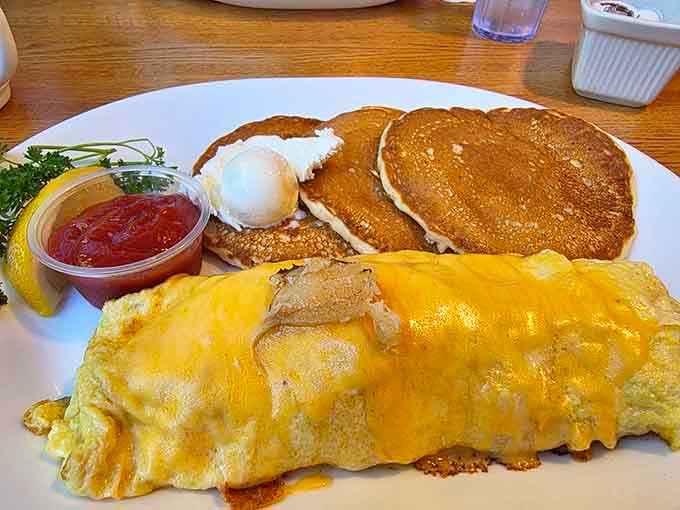 Golden pancakes meet a cheese-draped omelet in a breakfast power couple that would make any morning person weep with joy.
