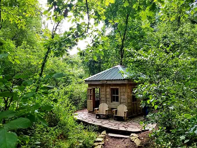 A peaceful wooden retreat tucked into the greenery, perfect for contemplating life's mysteries or just sitting quietly.