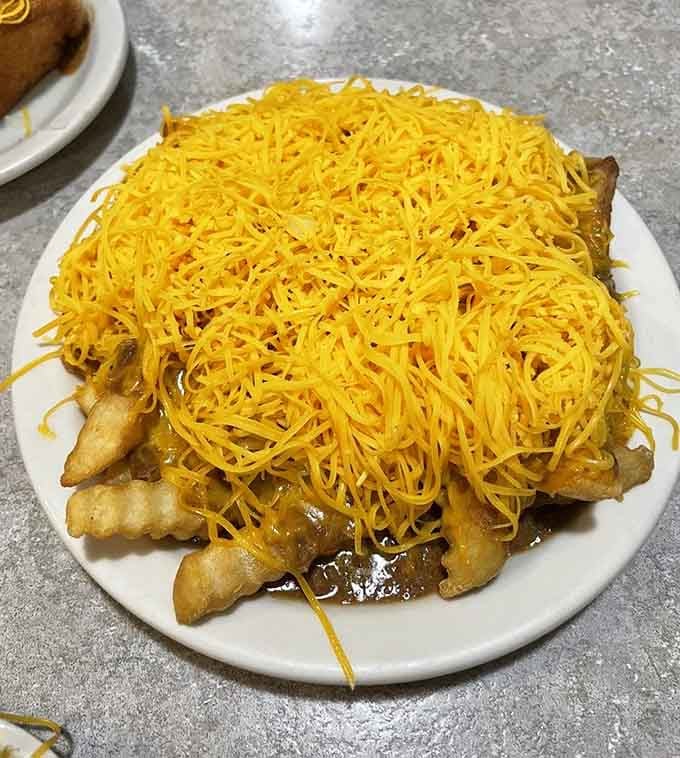 Chili cheese fries piled high enough to require architectural support, proving that sometimes excess is exactly what you need.