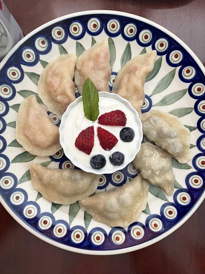 Pillowy pierogi arranged like edible art, proving that dumplings deserve the same respect as French pastries any day.