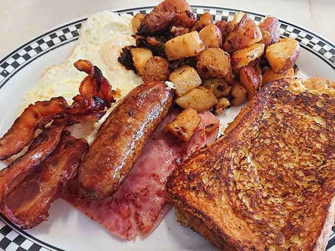 French toast, bacon, sausage, eggs, and home fries prove that breakfast doesn't believe in portion control or regrets.