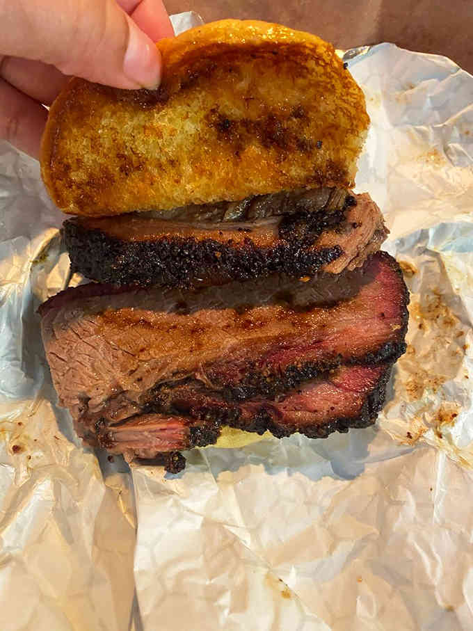 Three perfect slices of brisket stacked on Texas toast: this is what dreams are made of, folks.