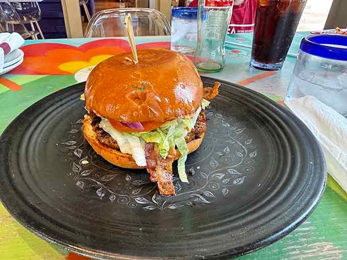 Behold the burger that makes you question reality: juicy, perfectly constructed, and utterly glorious in its simplicity.