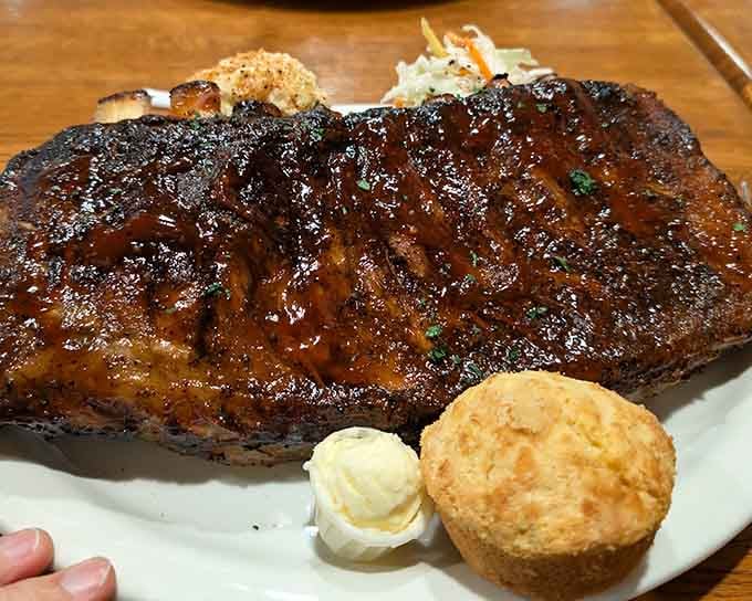 These ribs come with a side of butter and a biscuit because apparently someone understands life's priorities perfectly.