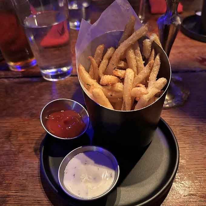Golden fries served in a coffin-shaped container, because regular baskets are for places without imagination or humor.