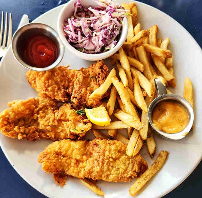 Golden, crispy fish with proper chips and purple slaw that's prettier than most sunsets you'll see this year.