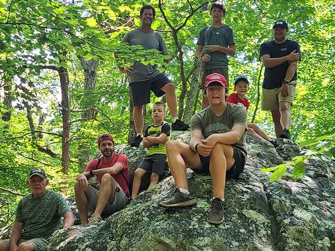 Nothing says "we conquered this rock" quite like a group photo atop ancient sandstone with matching grins.
