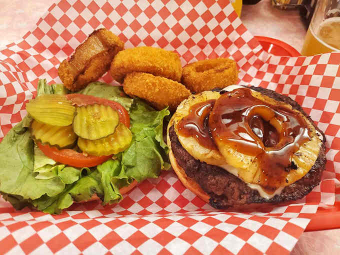 That burger's got more swagger than a '57 Chevy, complete with onion rings that crunch like happiness.