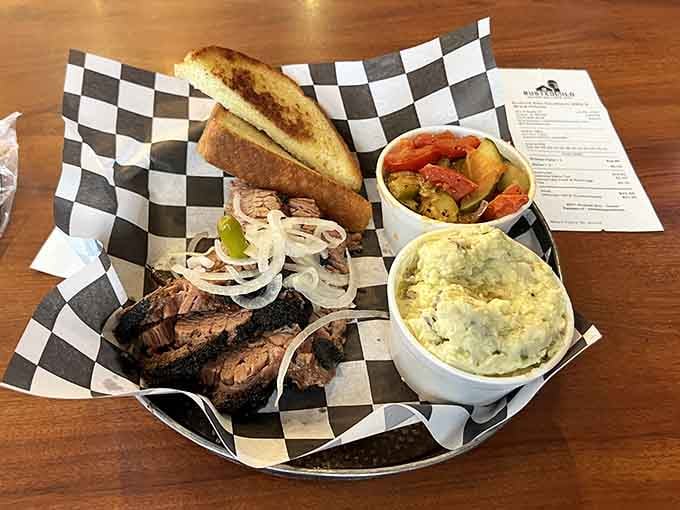 Brisket so tender it's practically waving hello, paired with sides that could headline their own show entirely.