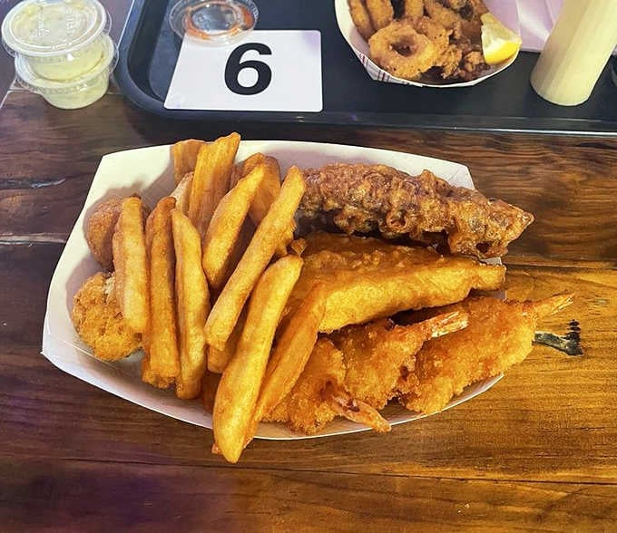 Golden perfection on a plate: crispy fish, seasoned fries, and those legendary hushpuppies stealing the spotlight once again.