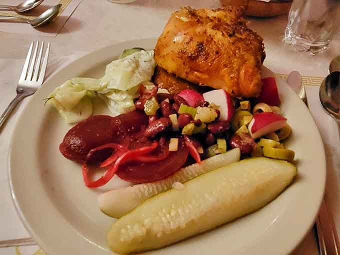 Golden roasted chicken alongside traditional sides proves that Polish comfort food deserves its own food group entirely.