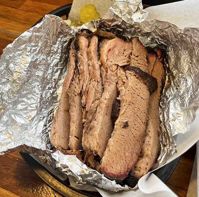 Behold the brisket: tender, smoky slices with that telltale pink ring proving someone knows exactly what they're doing back there.