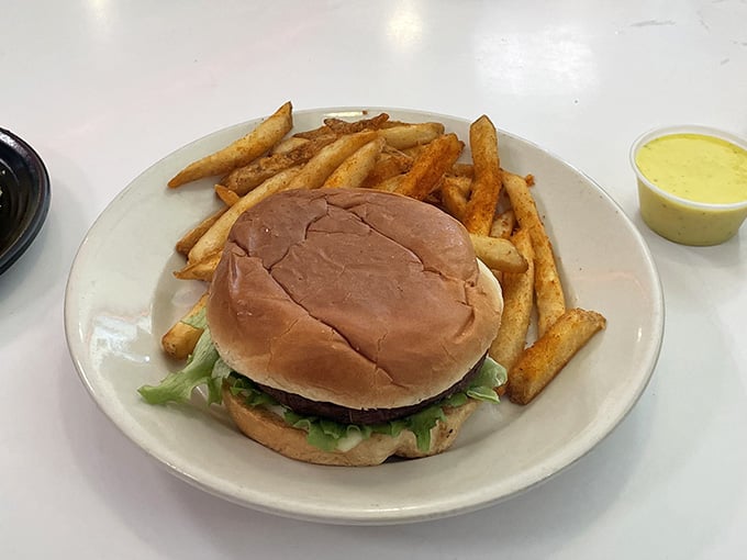 This veggie burger with golden fries proves that meatless options can still deliver serious satisfaction without the lecture about your choices.