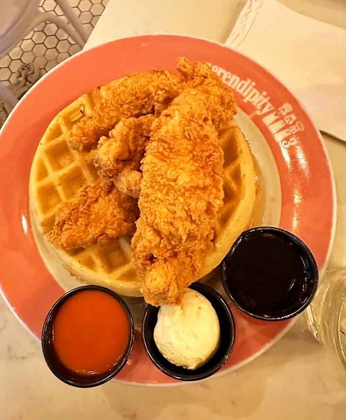 Golden fried chicken perched atop a Belgian waffle with three dipping sauces is basically breakfast meeting dinner for peace talks.