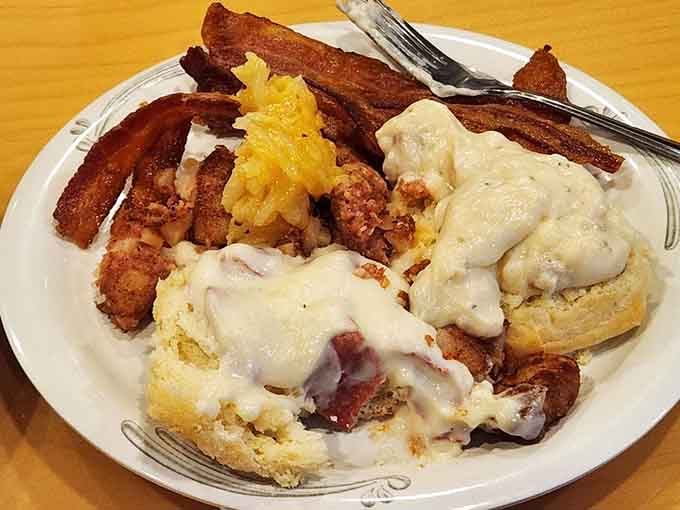 Biscuits drowning in gravy, bacon standing at attention, this plate means business and possibly a food coma.