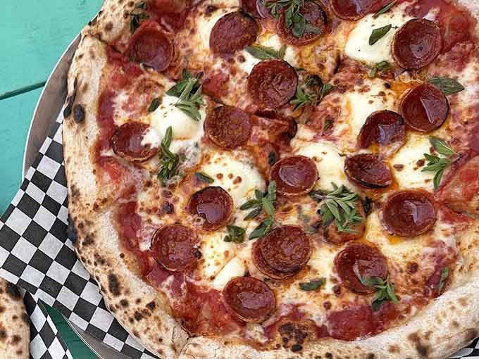 Pepperoni perfection with fresh herbs scattered across bubbled cheese, this is what pizza dreams are made of, friends.
