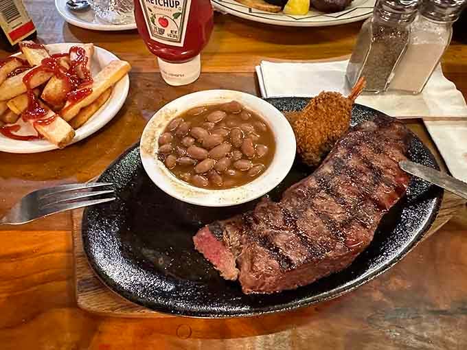 That NY strip arrives on a sizzling skillet with cowboy beans, proving simplicity done right beats fancy every time.