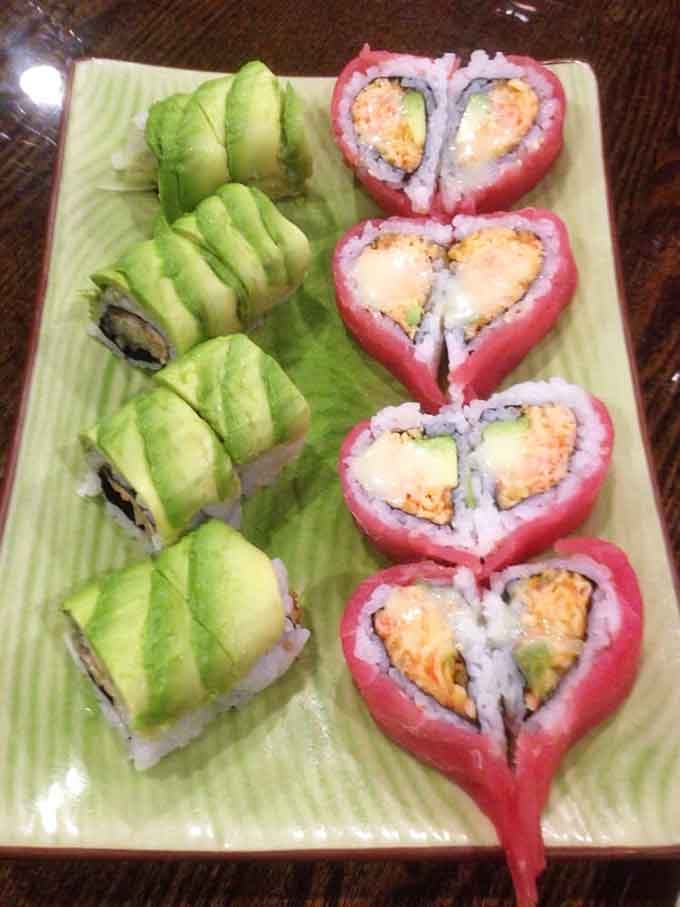 Fresh sushi rolls arranged like edible art, proving that buffet food can be beautiful and delicious simultaneously.