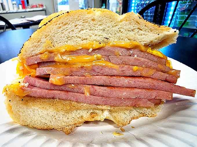 Behold the layers of perfectly cooked pork roll with melted cheese creating pure breakfast sandwich architecture.