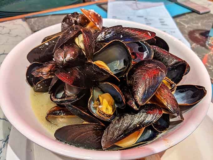 Steamed mussels glistening in their broth, ready to transport your taste buds straight to the New England coast.