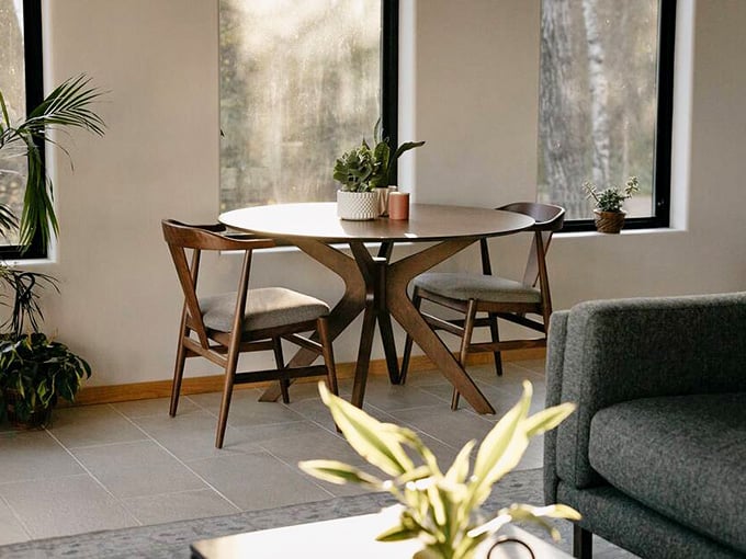 Mid-century modern dining furniture catches the morning light, creating the perfect spot for coffee and contemplation.