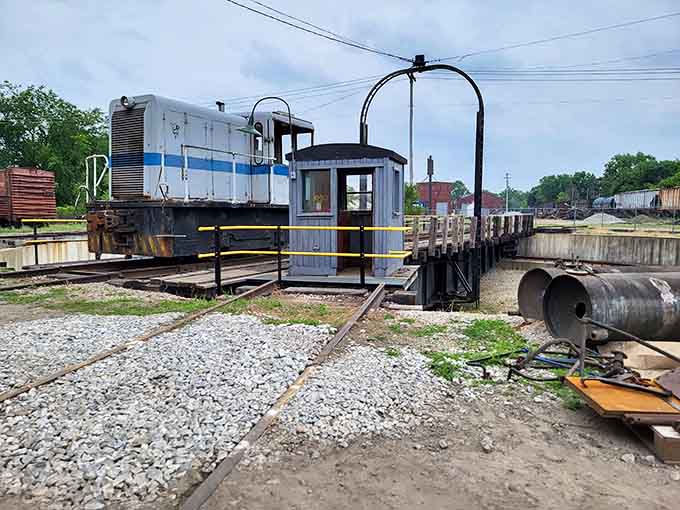 The turntable spins locomotives like a giant lazy Susan, proving that even massive machines need help changing direction sometimes.