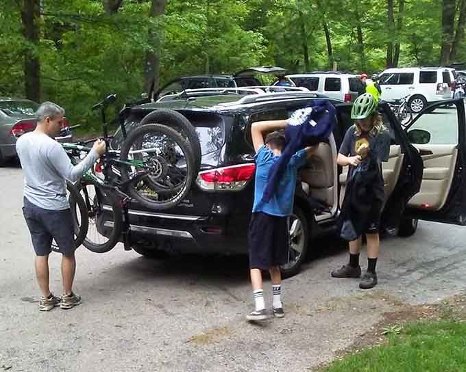 Real families unloading bikes for a day of adventure, proving that outdoor fun doesn't require a trust fund.