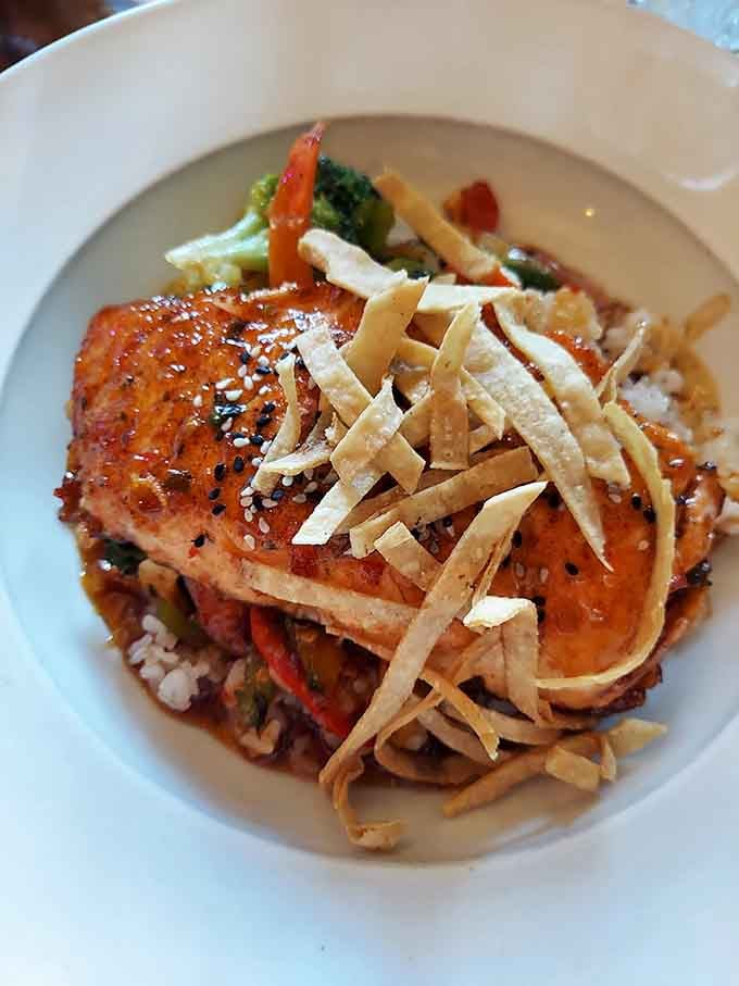 Perfectly seared salmon that makes you forget you're technically eating healthy, topped with crispy strips of pure joy.