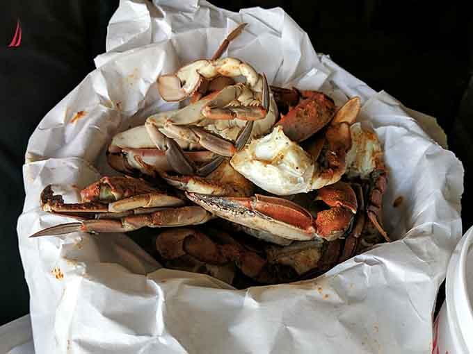 Fresh blue crabs piled high in paper, ready to be cracked open like delicious treasure chests from the sea.