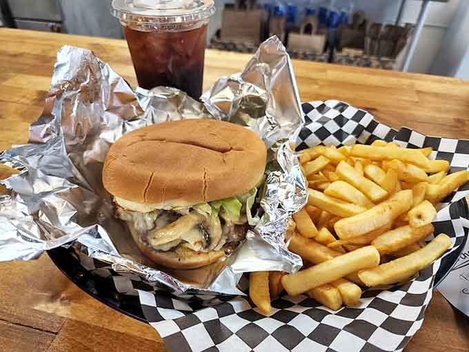 The Mushroom Swiss burger with golden fries proves that simple perfection never goes out of style.