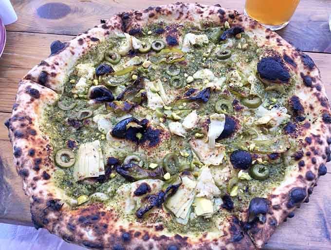 Those charred bubbles on the crust are like little flavor bombs, each one a testament to proper sourdough fermentation and high heat.