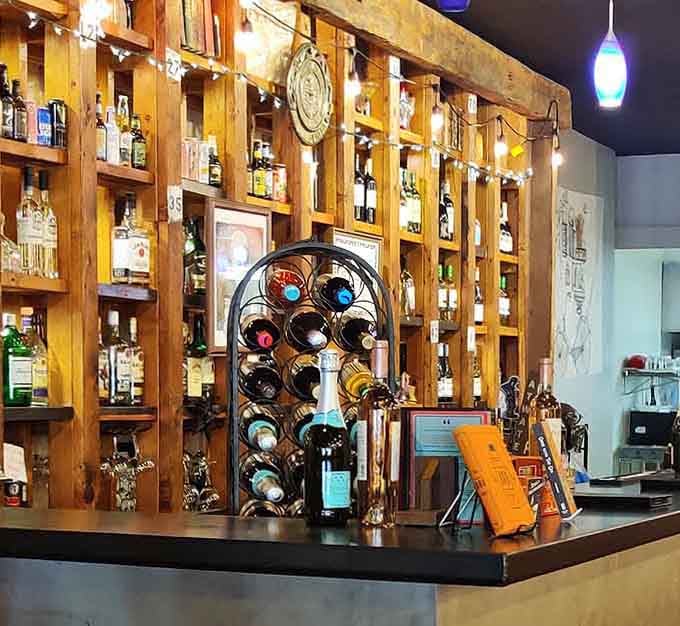 A rustic wine display that would make even your book club jealous, bottles lined up like literary classics.