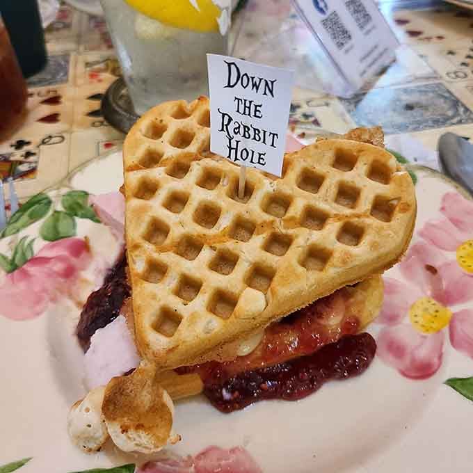 Heart-shaped waffles embrace bacon and jam in this "Down The Rabbit Hole" creation that redefines what sandwiches can aspire to be.