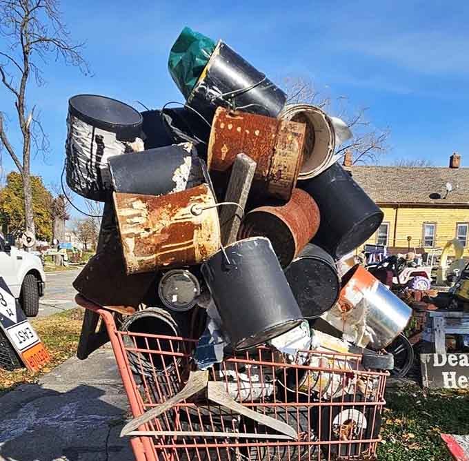 Shopping carts overflowing with rusty buckets somehow become poetry when stacked against a brilliant blue sky.