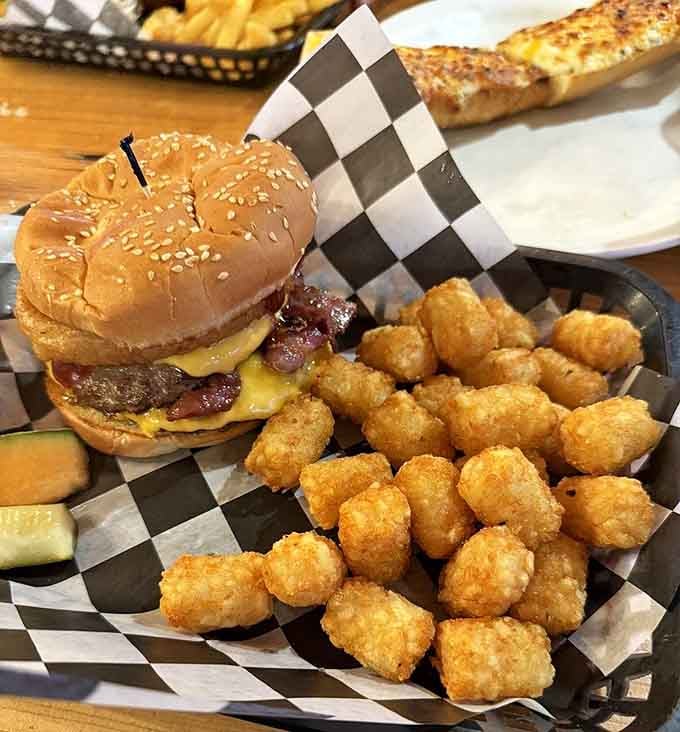The bacon cheeseburger arrives with crispy bacon and golden tater tots that'll make you forget every diet resolution.