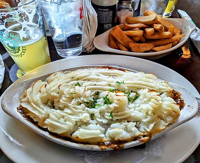 Shepherd's pie piled high with creamy mashed potatoes, looking like a fluffy cloud landed on your plate.