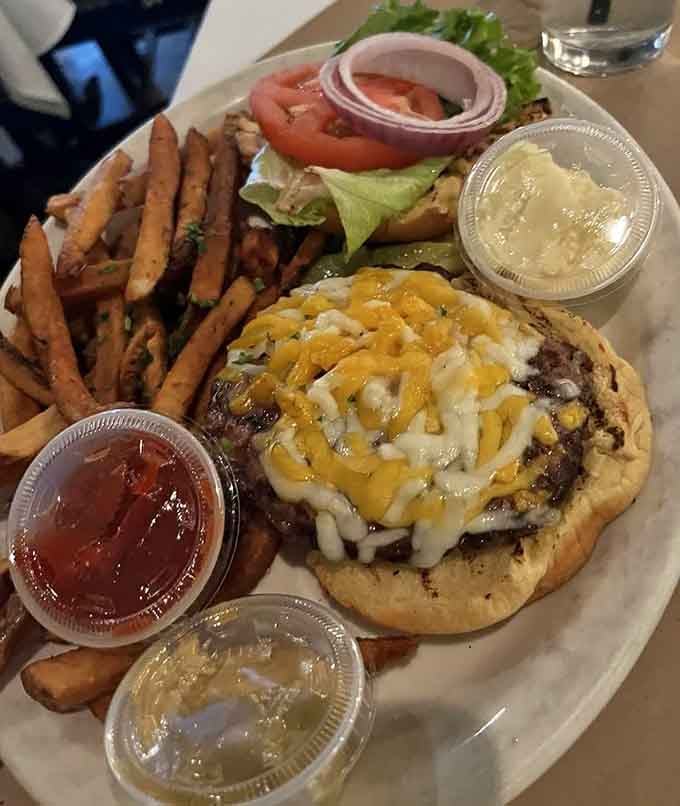 The Raven Cheeseburger arrives loaded with melted cheese and crispy fries, proving that comfort food never goes out of fashion.