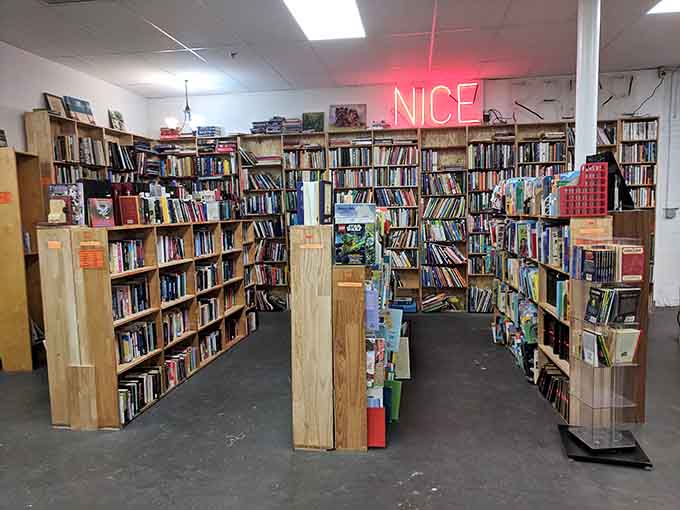 That neon "NICE" sign knows exactly what you're thinking as you browse shelves packed with literary possibilities and inspiration.