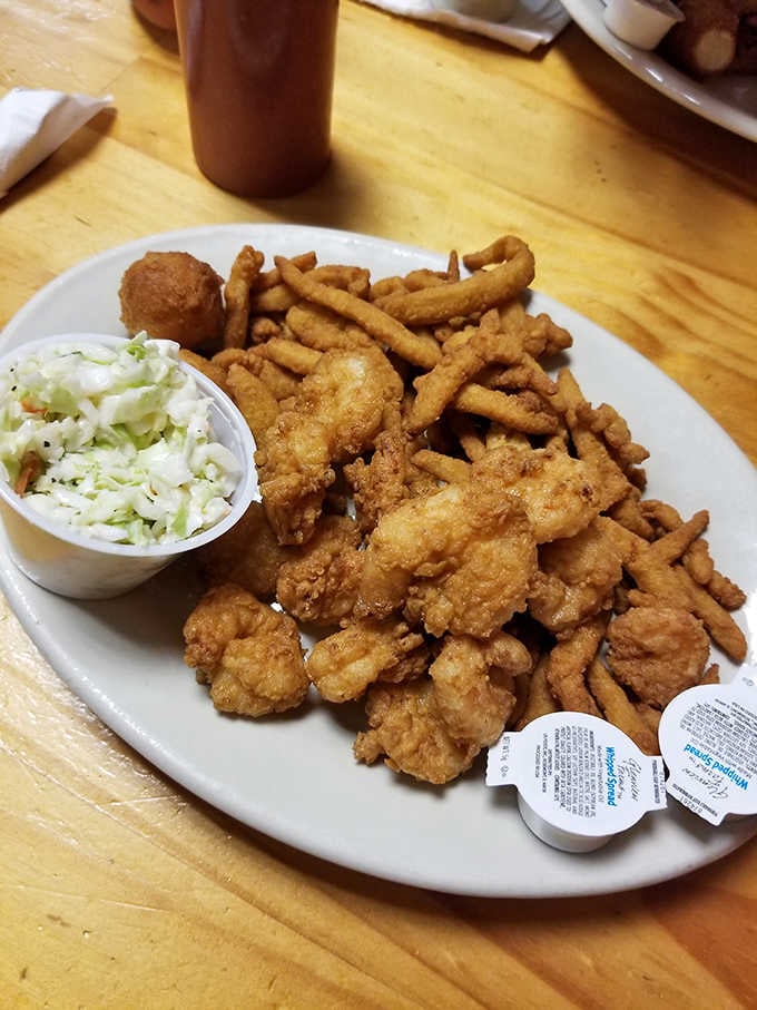 Golden-fried shrimp, crispy fries, and hush puppies form the holy trinity of Calabash-style seafood perfection.