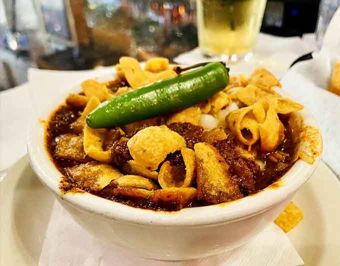 Frank's Frito Pie topped with Fritos, cheese, and a jalapeño – childhood nostalgia meets grown-up heat levels.