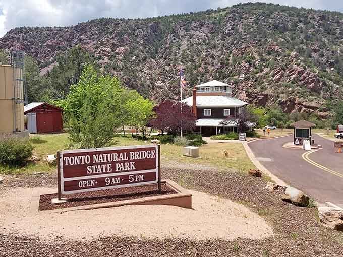 The park entrance welcomes visitors with rustic charm and mountains that tower like protective sentinels overhead.