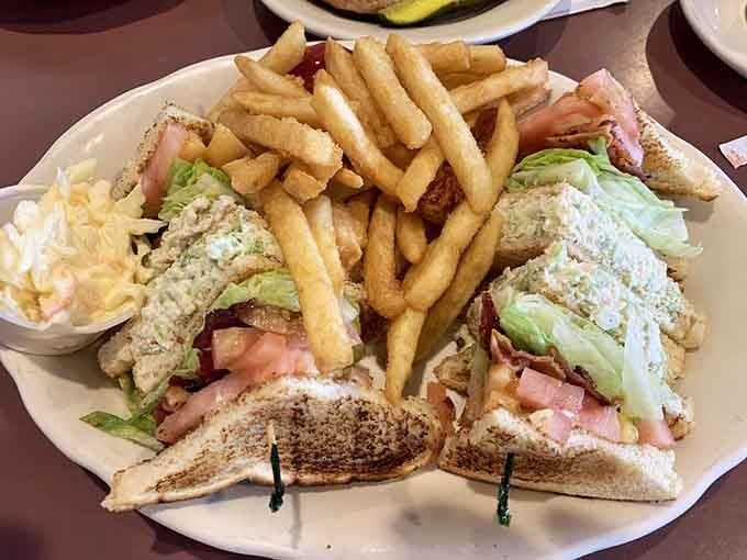 That chicken salad club with its mountain of fries is basically three meals pretending to be one plate.