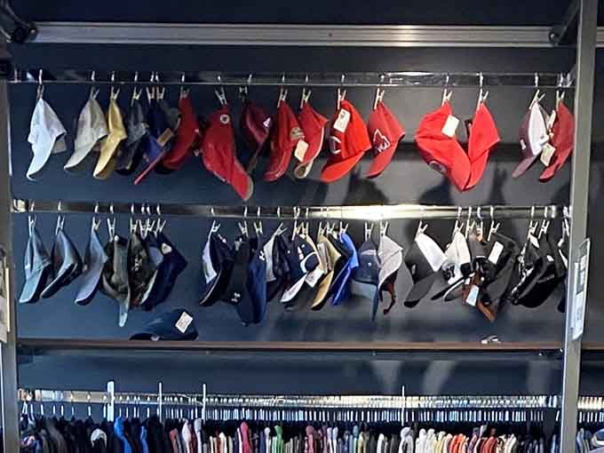 Baseball caps organized by color like a rainbow for your head, from classic reds to cool blues.