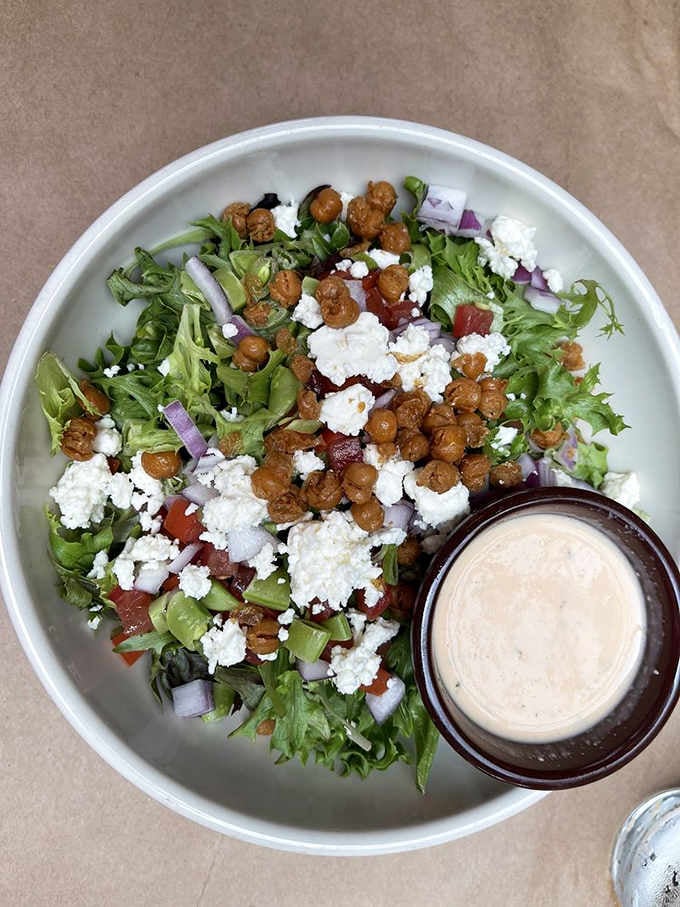 Fresh greens topped with crispy chickpeas and feta make healthy eating feel less like punishment, more like pleasure.