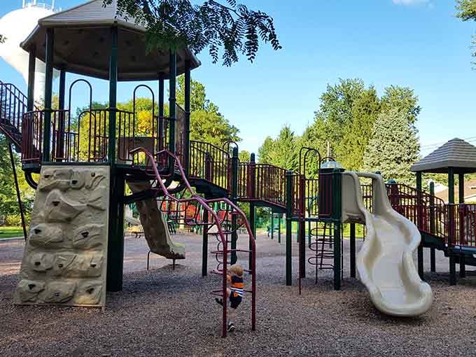 This playground setup looks ready to tire out the grandkids while you enjoy a peaceful bench moment.