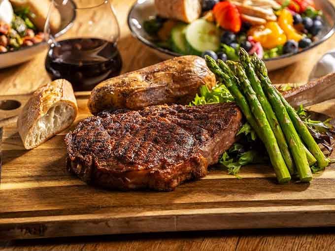 That tomahawk steak commands respect, arriving at your table like it just won the Wild West lottery.