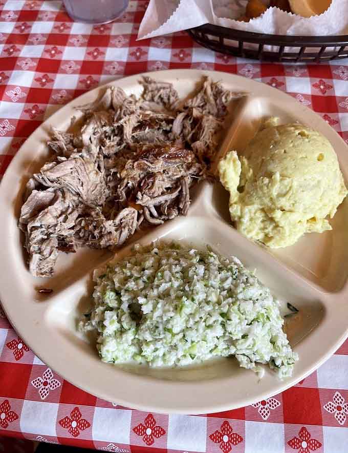 Behold the holy trinity of Eastern Carolina barbecue: chopped pork, vinegar slaw, and boiled potatoes that know their place.